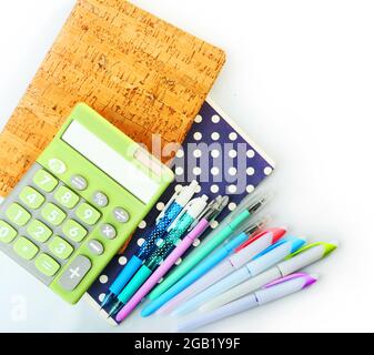 A pile of stylish notebooks and stationary, isolated on white ...