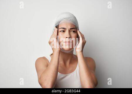 woman holding onto bandaged head injury health problems treatment Stock ...