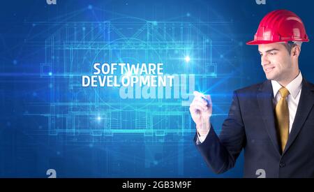 Handsome architect with helmet drawing SOFTWARE UPDATE inscription, new ...