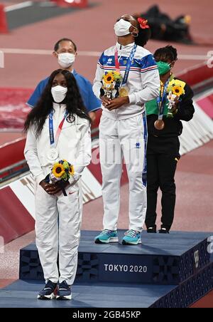 Bronze medalist Jasmine Camacho-Quinn, of Puerto Rico, embraces Cyréna ...