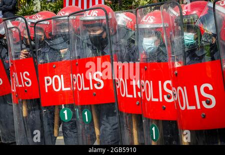 Federal Reserve Unit (FRU) police officers block a road during a ...