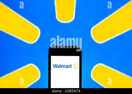 In this photo illustration, a Walmart logo is seen displayed on a ...