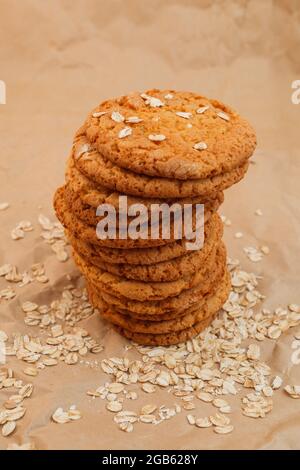oatmeal cookies and scattered oatmeal on crumpled paper background ...