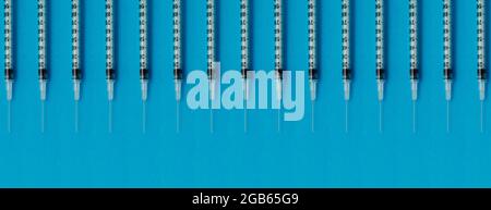 medical syringes on blue panorama background Stock Photo - Alamy