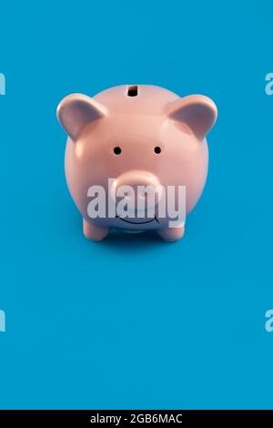 red piggy bank on blue panorama background Stock Photo - Alamy