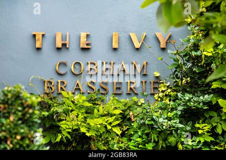 Sign on the exterior of The Ivy Cobham Brasserie, Cobham, Surrey, UK ...