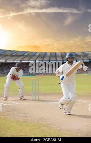 Cricket batsman is running Stock Photo - Alamy