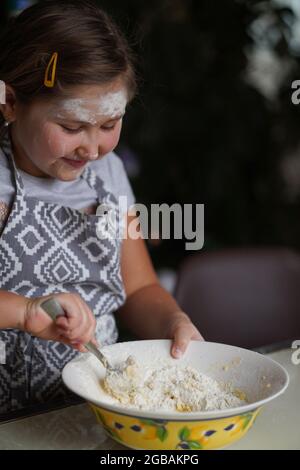 Mother and daughter prepare Christmas cookies and decorate them with ...