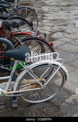 Rusty old bike in a cobbled street of half-timbered medieval houses in ...
