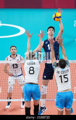 Alessandro Michieletto of Italy, top, spikes the ball against Belgium's ...