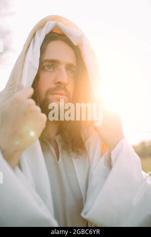 Jesus Christ standing clothed in his traditional white robe against sky ...