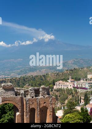 Scenic view of famous Mount Etna covered with clouds and smoke during ...