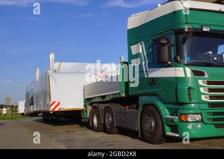 Very long vehicle. Oversize load or exceptional convoy. A truck with a special semi-trailer for ...
