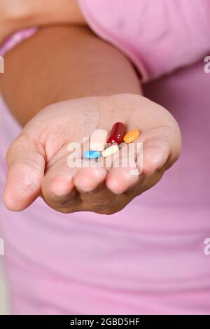 colorful pills in the palm of your hand pain reliever health treatment ...