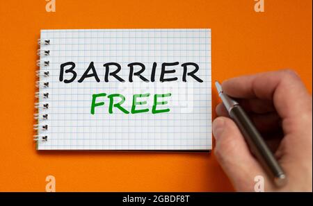 Barrier free symbol. Businessman writing words 'Barrier free' on white ...