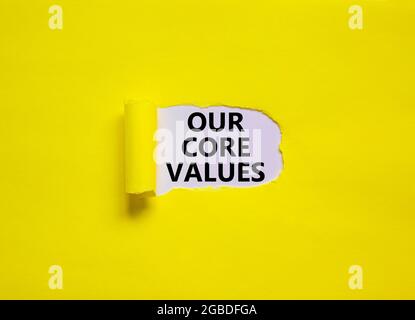 Our core values symbol. Words 'Our core values' appearing behind torn ...