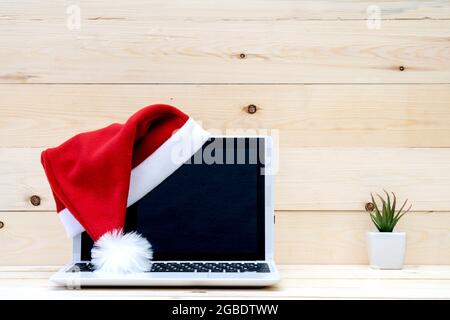laptop with blank screen and Santa Slaus hat Stock Photo - Alamy