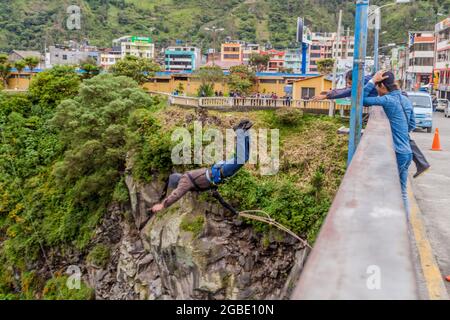 BANOS, ECUADOR - JUNE 20, 2015: People performing bridge jumping ...
