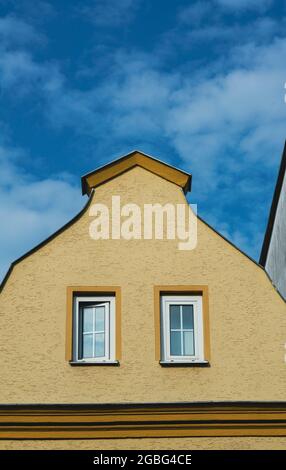 A vertical shot of a modern interesting building with balconies on the ...