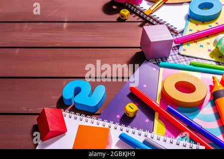 School supplies on wooden boards background. Album, notebooks, felt-tip ...