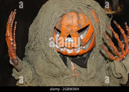 Jack-O-Lantern pumpkin, skeleton hands, skull and fallen leaves on ...