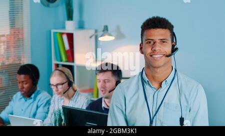 Portrait of multiracial customer service operator in headset smiling to ...