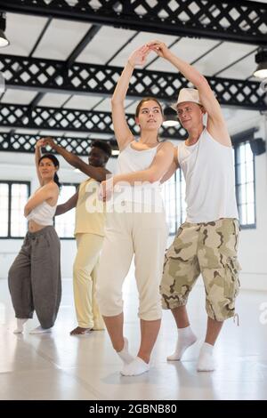 Four dancers exercising bachata movements Stock Photo - Alamy
