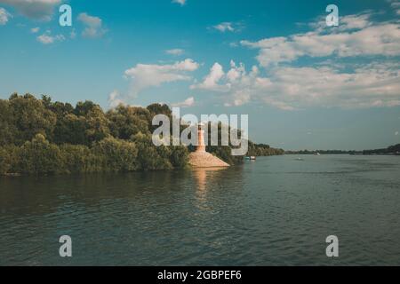 Scenic view of a lighthouse in Danube River under a cloudy sky Stock ...