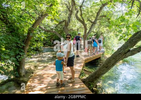 KRKA, CROATIA - Jul 09, 2021: The people walking on a wooden platform ...