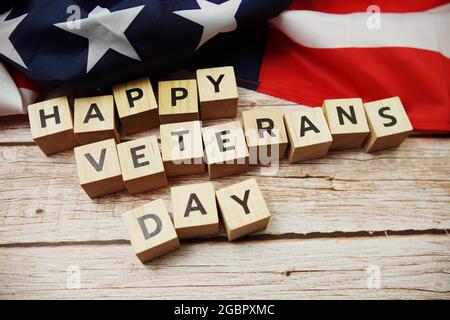 Happy Veterans Day alphabet letter and American flag on wooden ...