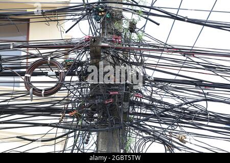 Tangled messy electrical wires on pole posing a safety hazard Stock ...