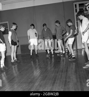 1960s, historical, inside the the hall of a youth club, three teenage ...