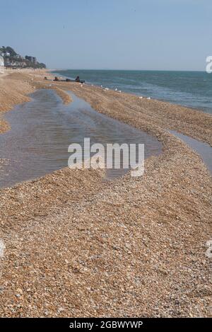 View along quiet shingle beach in north Kent resort on Thames estuary ...