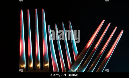 Closeup of three silver forks on a black background Stock Photo - Alamy