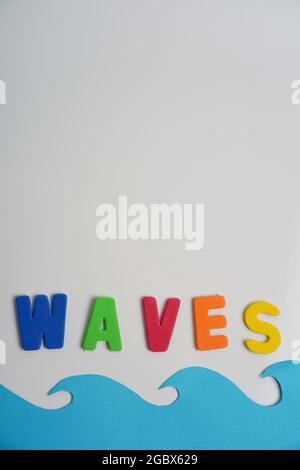 Word waves written in colored alphabets on a frame with a pink ...
