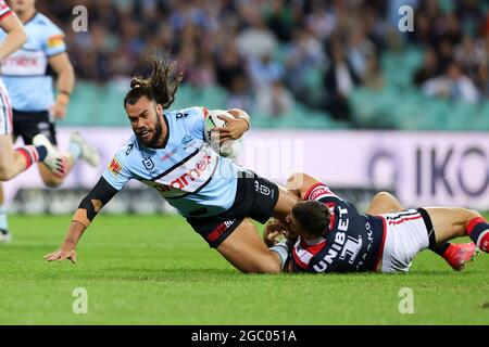 Toby Rudolf of the Sharks is tackled during the NRL Round 27 match ...