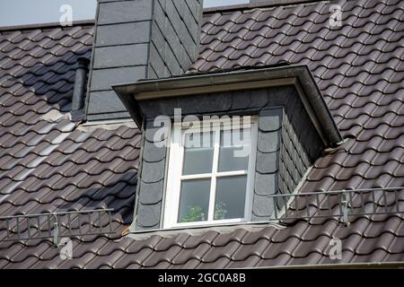 New tiled roof with slate cladded chimney Stock Photo - Alamy