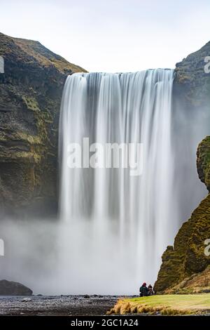 Mesmerizing view of a waterfall between the stone wall and a hill ...