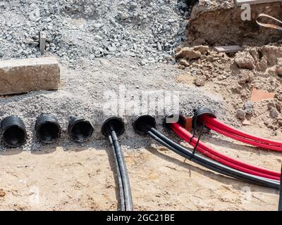 Underground utility and services pipe laid by workers in the trenches ...