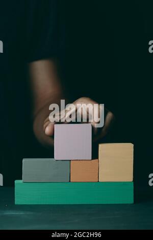 Closeup of a hand playing with wooden blocks on the bar table Stock ...