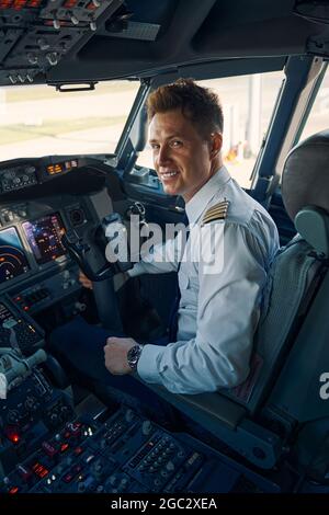 Pilot, co-pilot and flight deck personnel do a pre-flight check of an ...