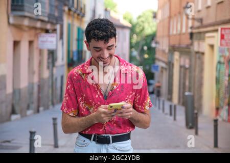 Young caucasian man with long false nails dancing at street ...