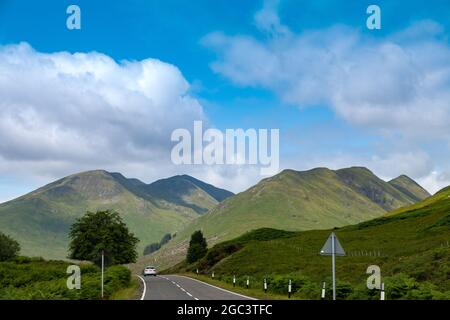 Driving along the A87 through Glen Shiel in the Scottish Highlands ...