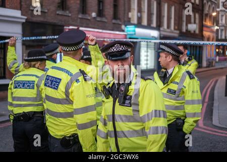 A cordon of Metropolitan Police Officers on duty in central London ...