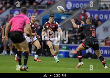 John Bateman (13) of Wigan Warriors offloads the ball despite the ...