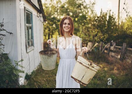 pretty woman with buckets in hand nature Lifestyle Stock Photo - Alamy