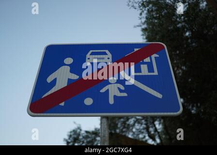 A blue information sign on a metal wire fence with a white graphic icon ...