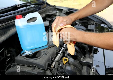 Motor mechanic cleaning his greasy hands after servicing car Stock ...