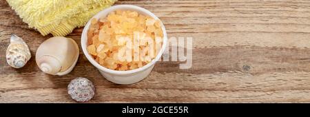 Soft towels, sea salt and shells on wooden background. Spa concept ...
