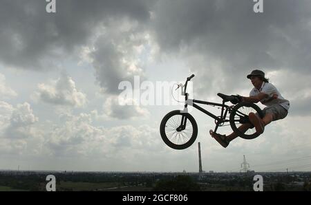 Young boys doing dare devil bicycle stunts in woodland near Budapest in ...